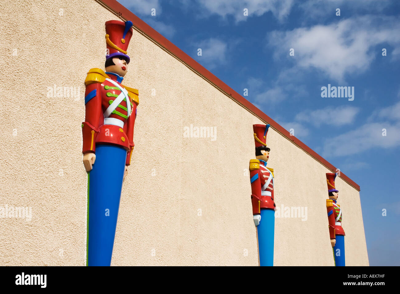 Brightly colored / coloured model soldiers on a building with a blue ...