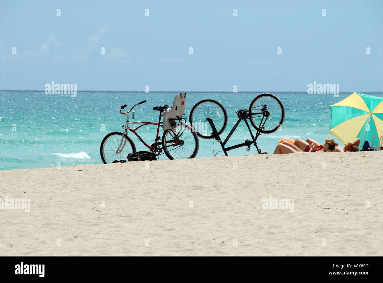 Beach Bikes and Sun Bathers Stock Photo - Alamy