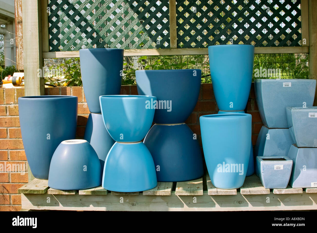 blue pots stacked up in garden centre ready for sale Stock Photo - Alamy