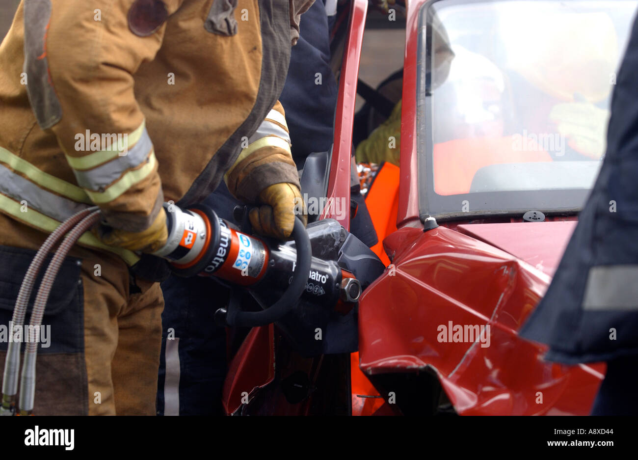 Firefighters cut open a car during a training drill Stock Photo - Alamy