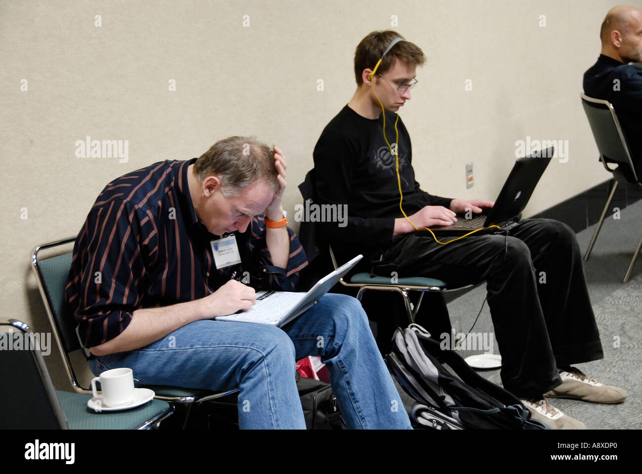Adult businessman professional works on wireless laptop computer while ...