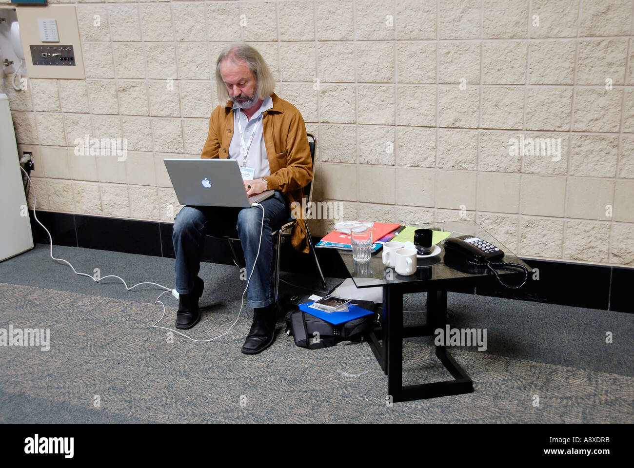 Adult businessman professional works on wireless laptop computer while ...