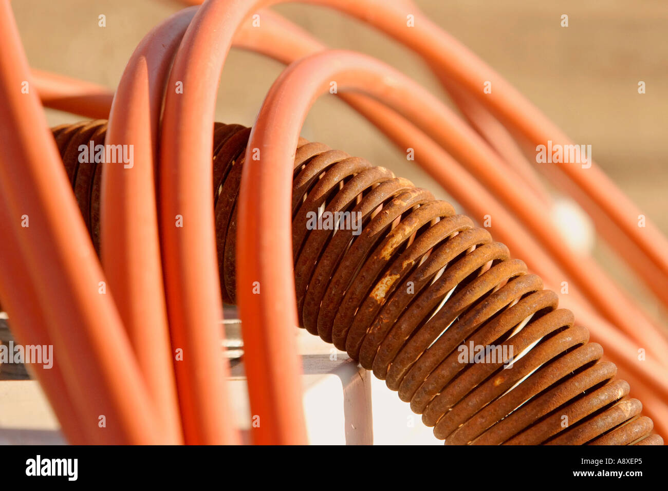 Pressure hose and rusting spring Stock Photo - Alamy
