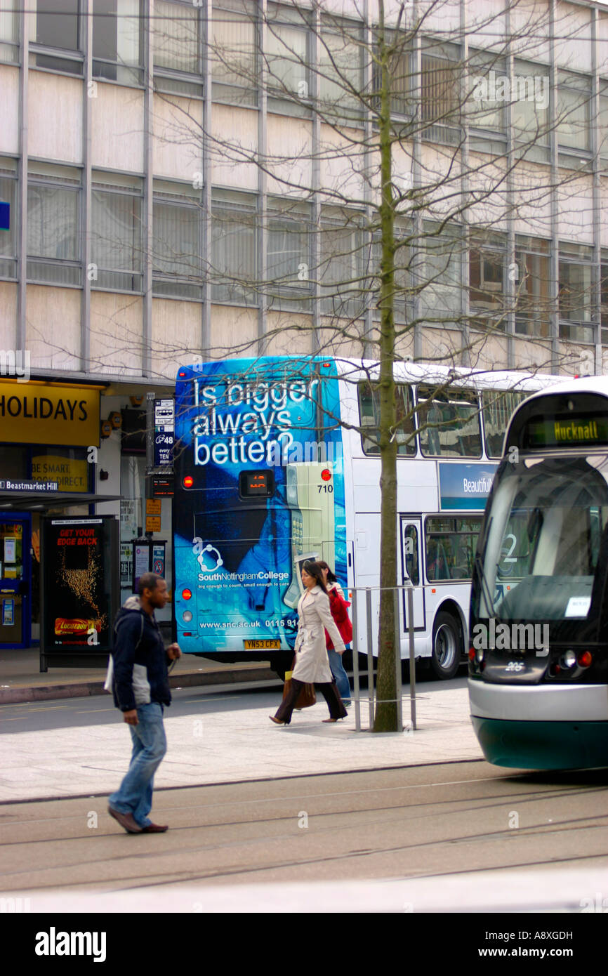 A Nottingham Tram and a Nottingham bus pass each other in Nottingham's ...