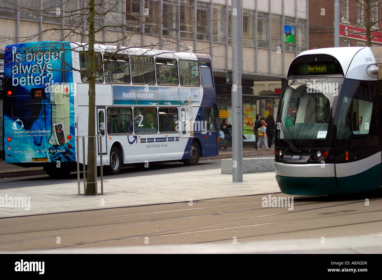 A Nottingham Tram and a Nottingham bus pass each other in Nottinghams ...