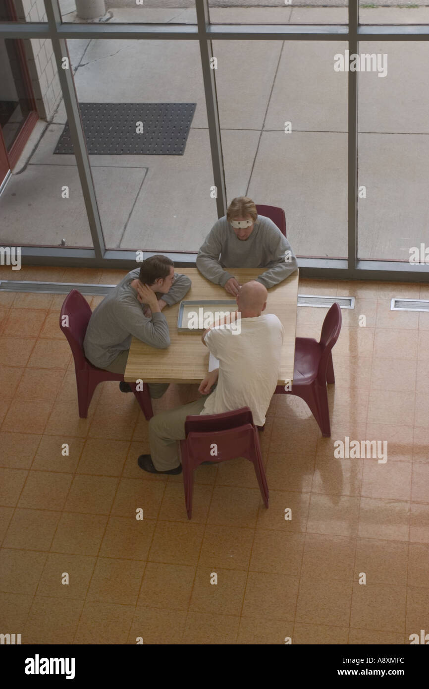 Group of prison inmates playing game in recreational area at their cell ...