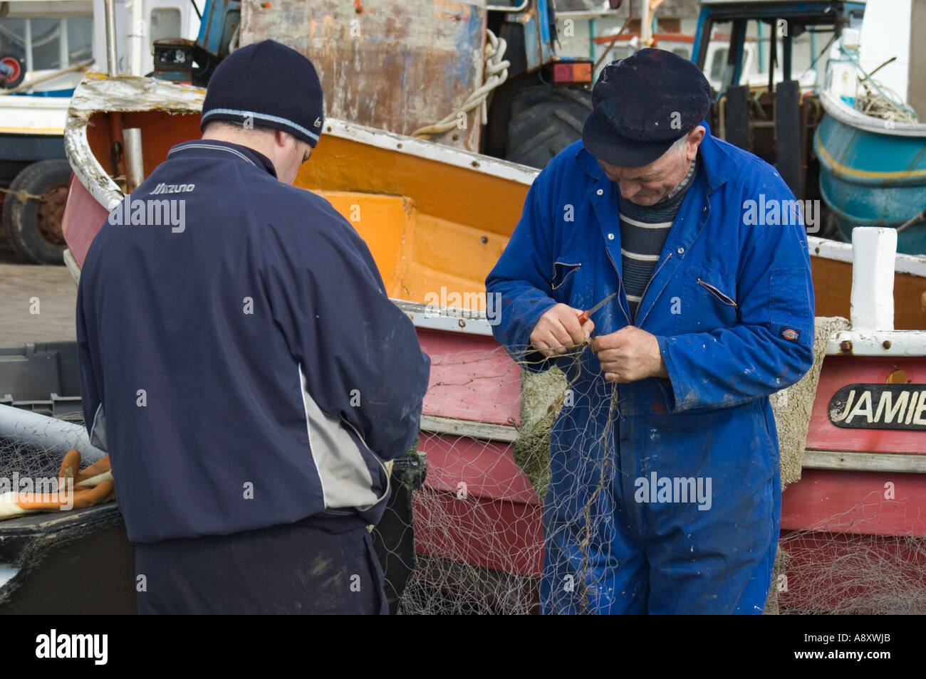Fishermen repairing their Salmon nets on the Coble landing Filey North ...