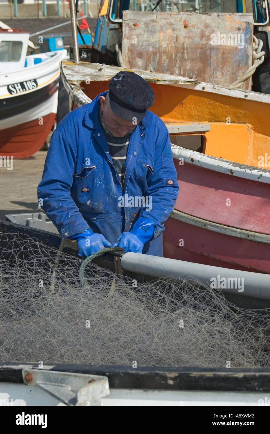 Fishermen repairing their nets on the Coble landing Filey North ...