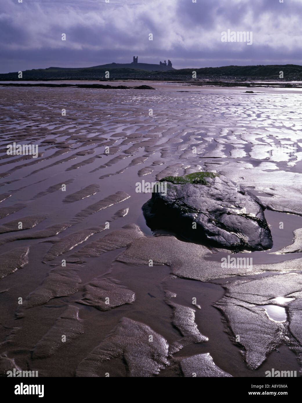 Moody skies over Dunstanburgh Castle, from Embleton Bay, Northumberland ...