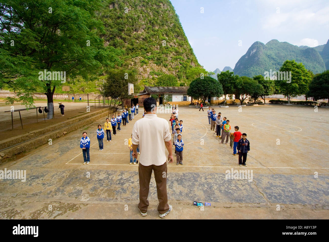 Instructor Speaking to Students at Outside School Assembly near ...