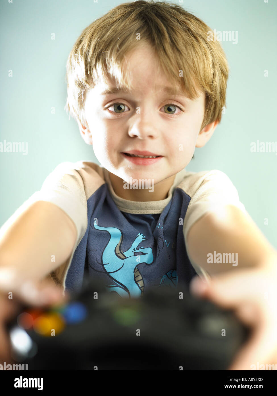 boy 6yrs excited playing on game console Stock Photo - Alamy