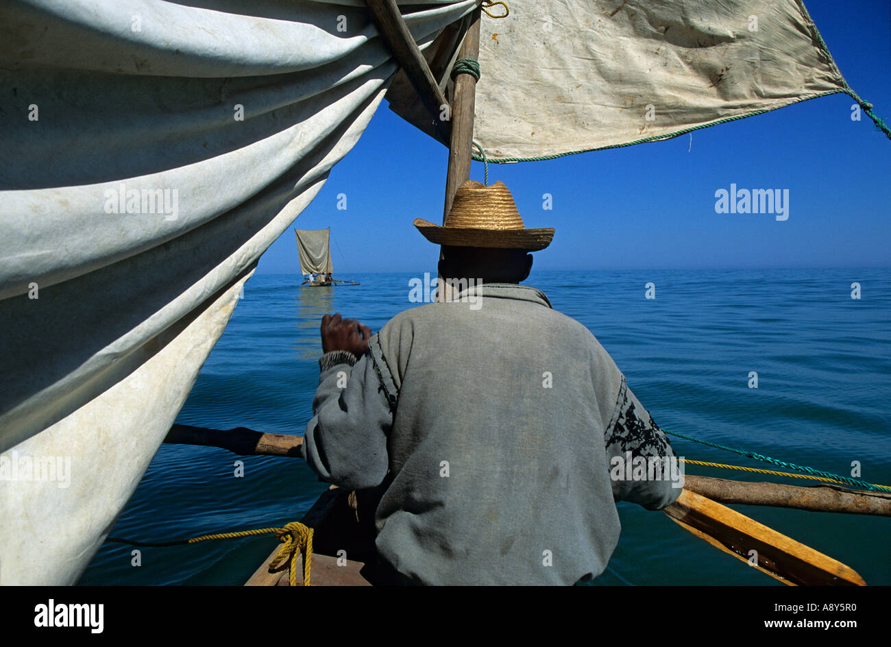 Paddling boatman on his outrigger (Madagascar). Piroguier ramant dans ...