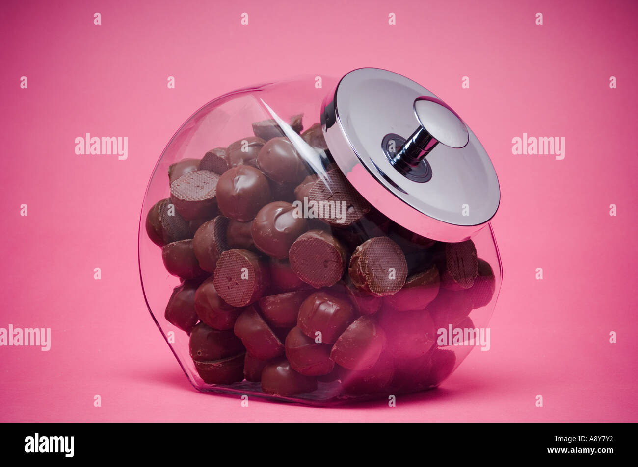 Chocolate candy in glass container Stock Photo - Alamy
