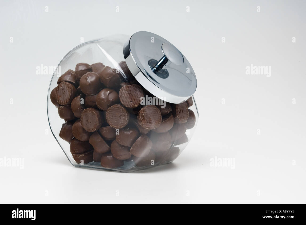 Chocolate candy in glass container Stock Photo - Alamy