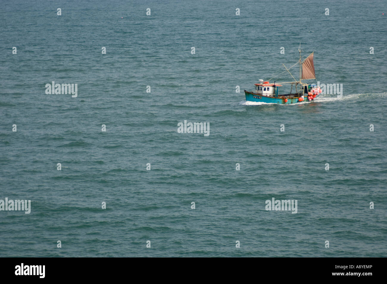 Small inshore fishing boat returning to the harbour Tenby pembrokeshire ...
