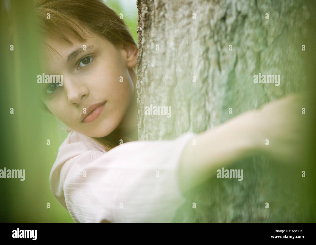 Girl hugging tree Stock Photo - Alamy