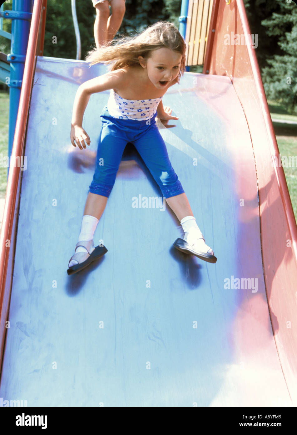 sliding down on slide MR8409 Stock Photo - Alamy