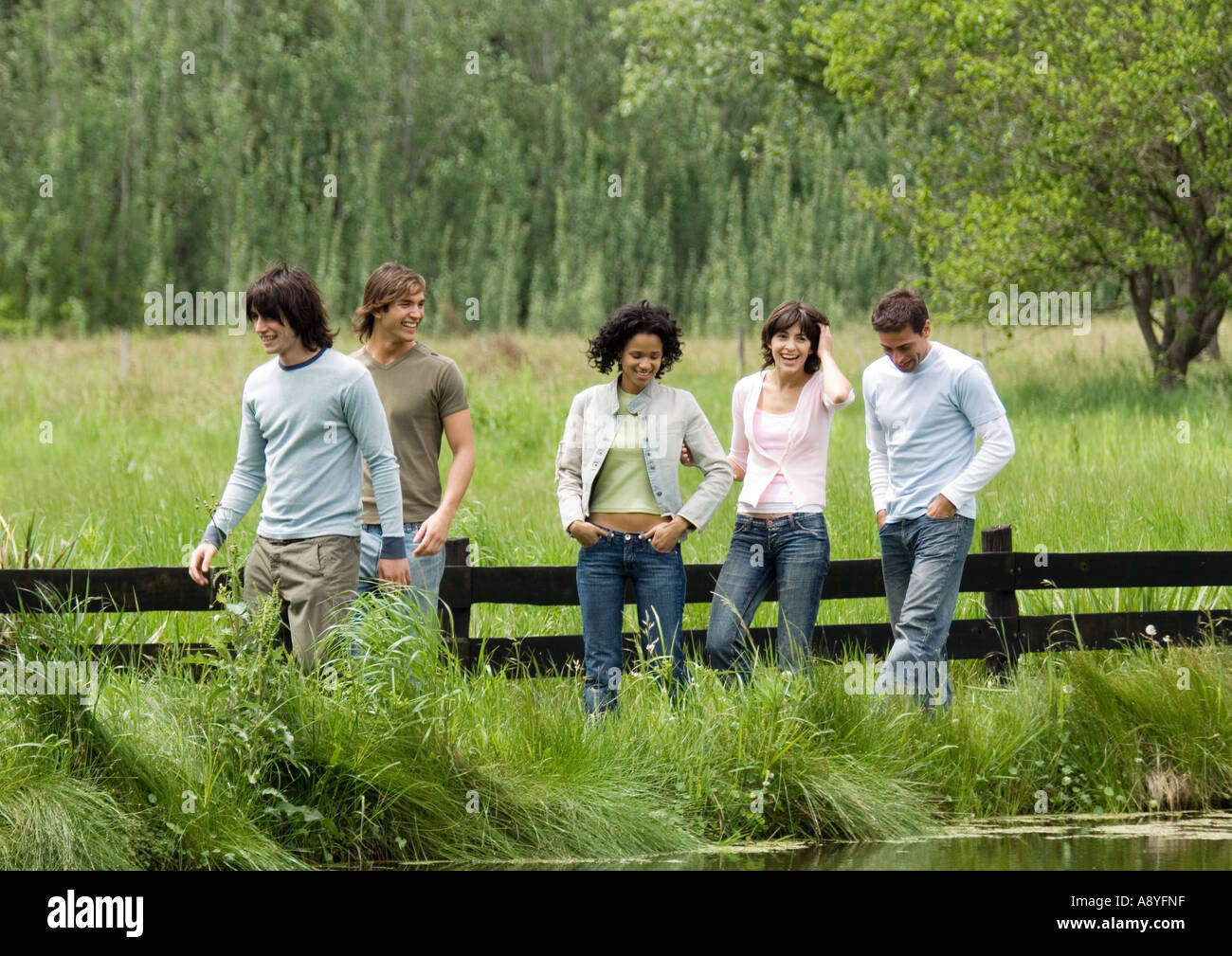 Group of young friends walking outdoors Stock Photo - Alamy