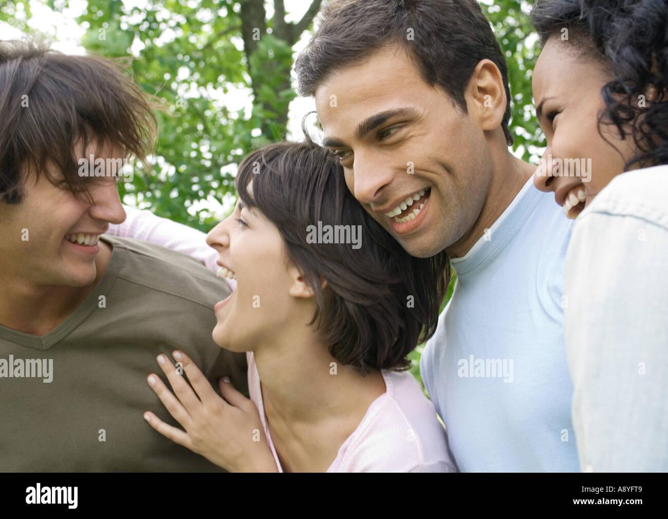Four young friends laughing Stock Photo - Alamy