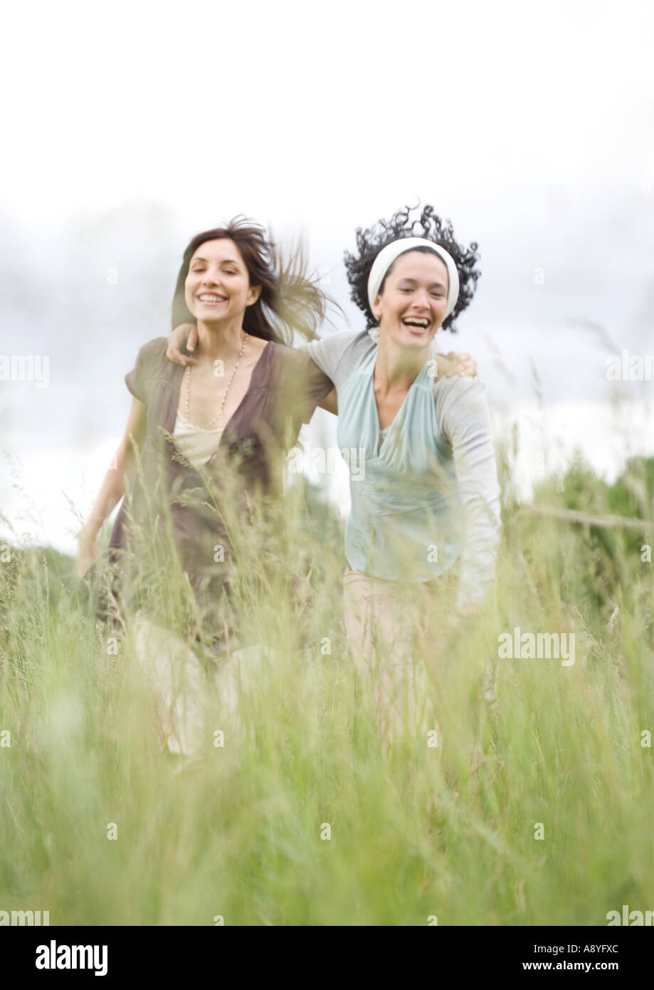 Three friends walking arms around hi-res stock photography and images ...