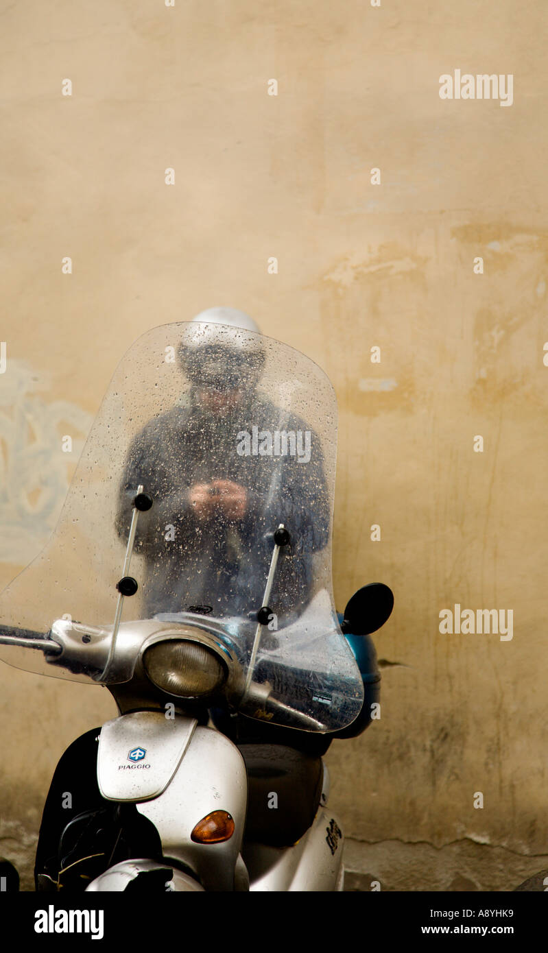 Scooter in the rain in Florence, Italy Stock Photo - Alamy