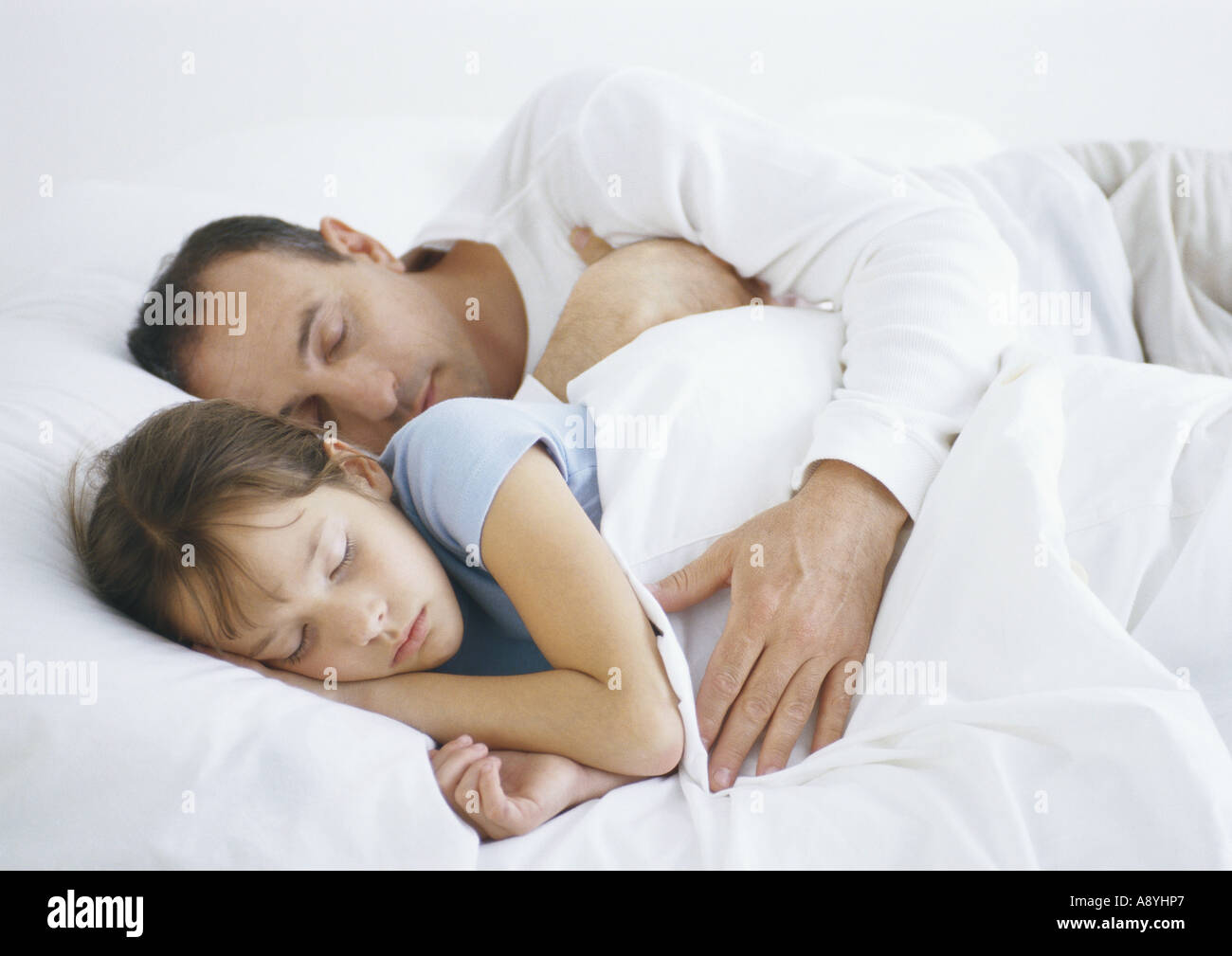 Family of three people sleeping in one bed hi-res stock photography and ...