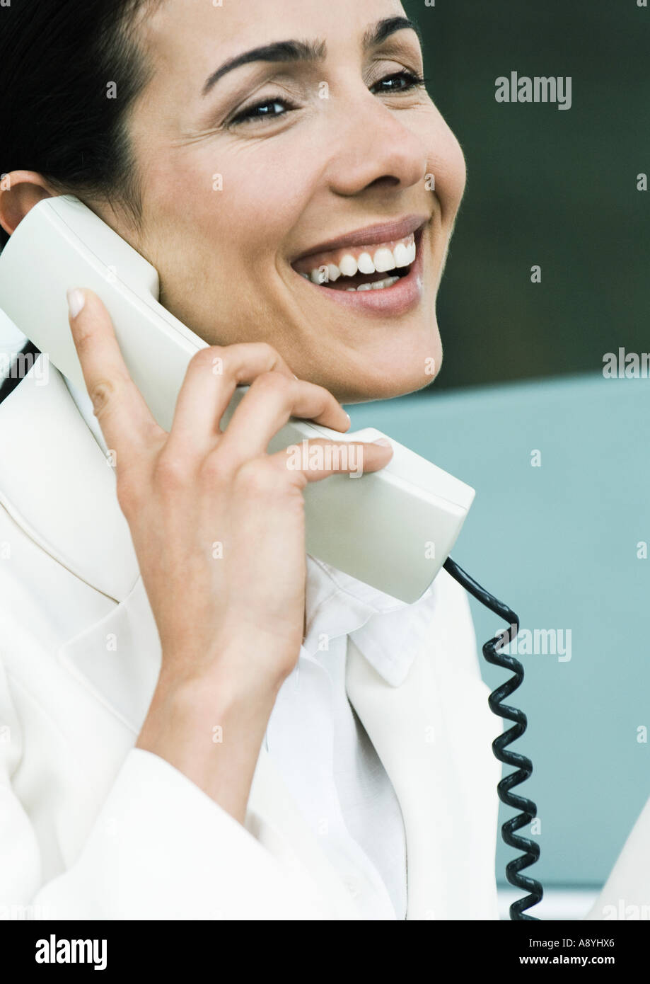 Businesswoman using landline phone, laughing Stock Photo - Alamy Businesswoman using landline phone, laughing Stock Photo - Alamy