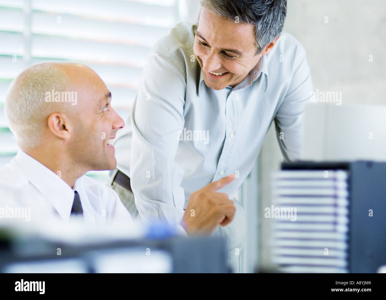 Office interactions, two men talking Stock Photo - Alamy