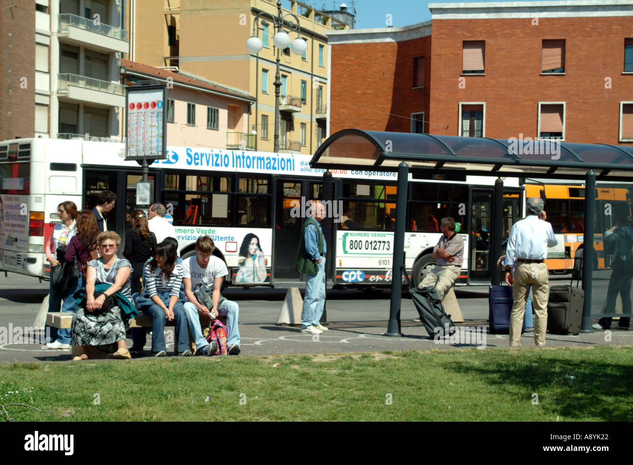 Passengers at bus stop wait for bus coach at Pisa Central railway ...