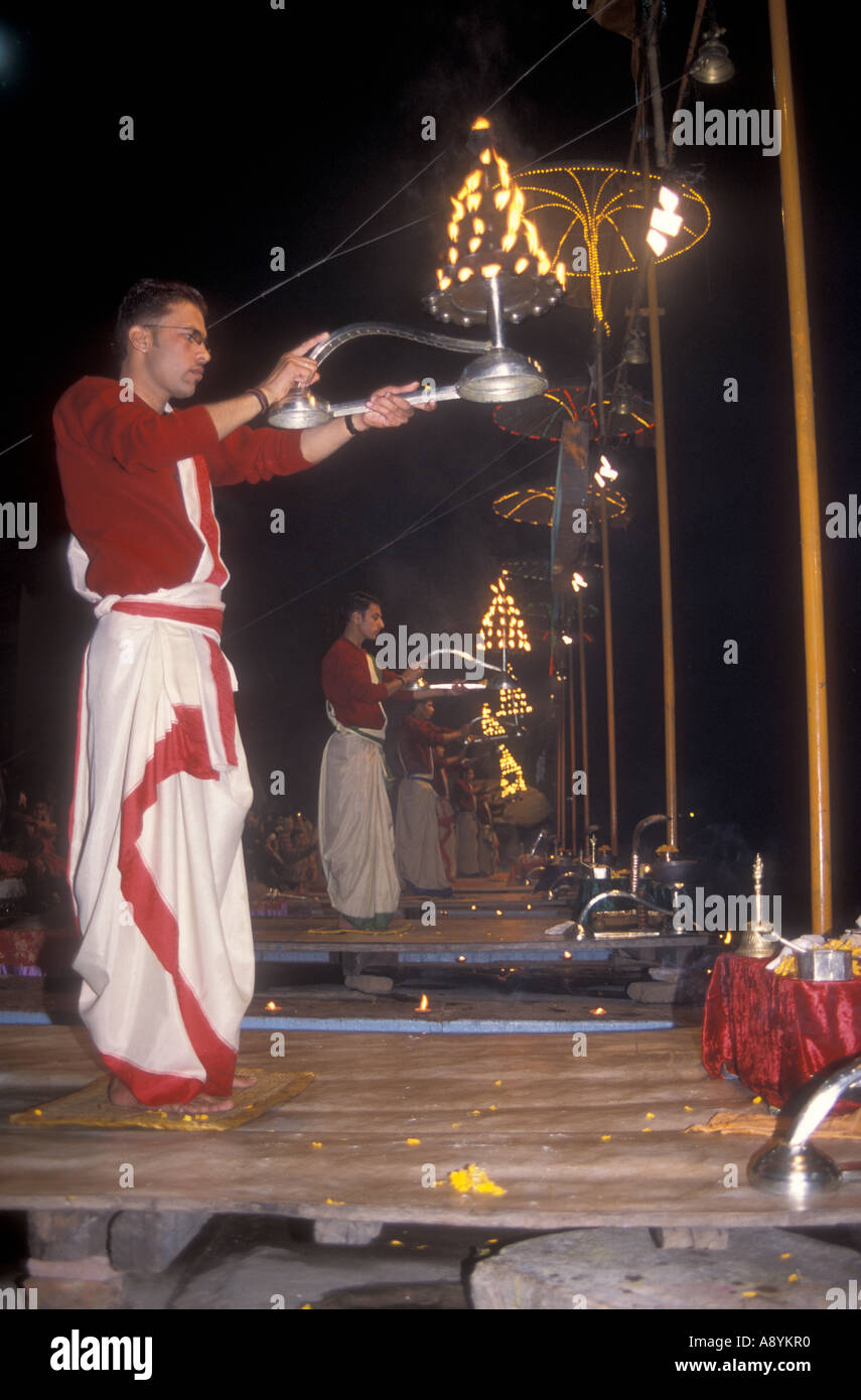 Hindu priests performing the Deepmala Ceremony at a Ghat on the banks ...