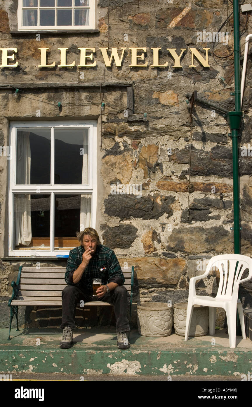 Man drinking and smoking cigarette sitting outside Prince Llewelyn pub ...