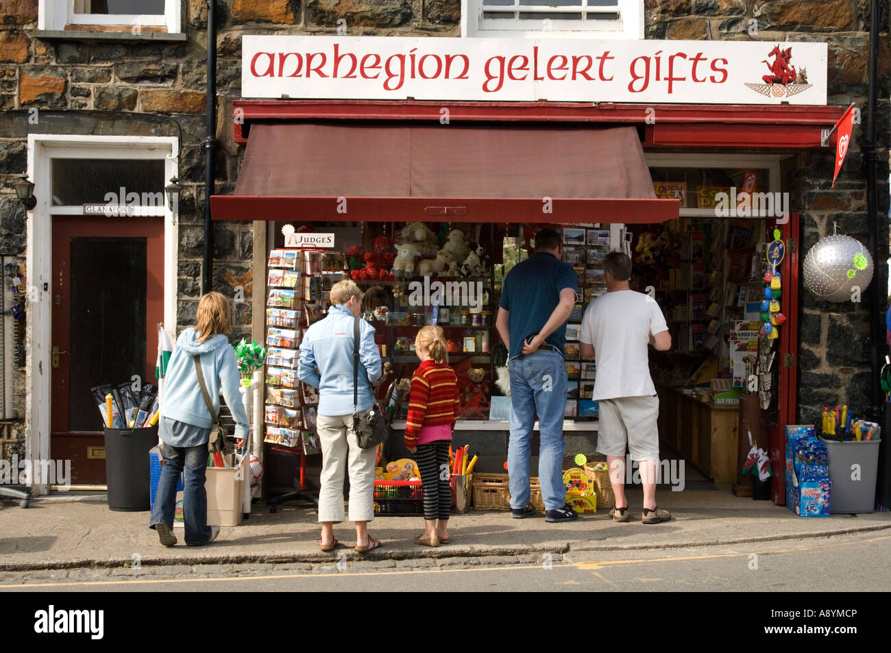 tourists and visitors shopping at gift shop Beddgelert snowdonia ...