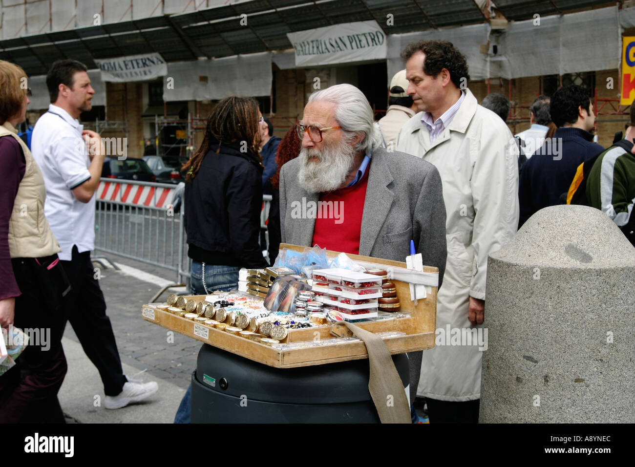 Old man selling Vatican items Stock Photo - Alamy