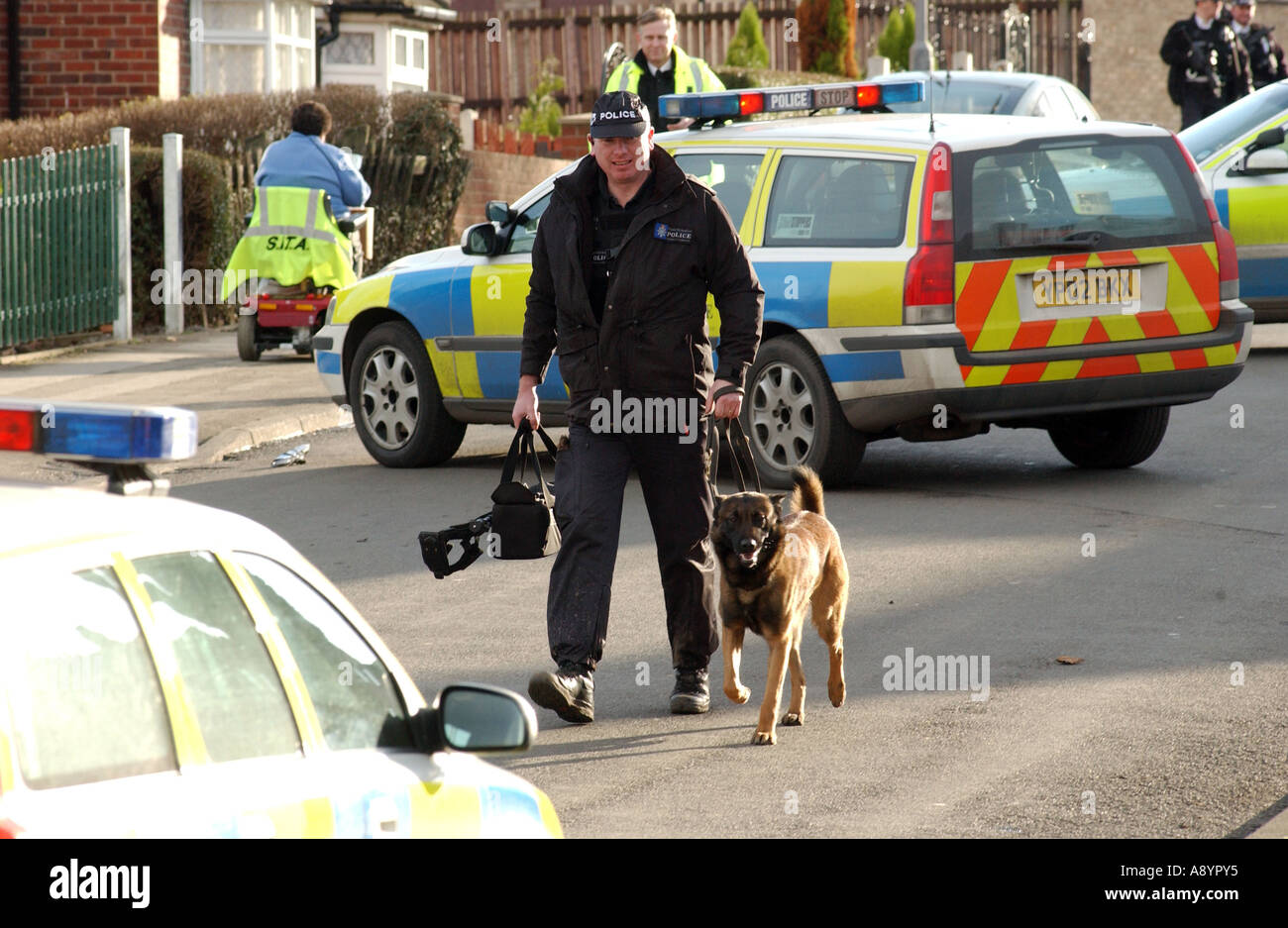 Armed police response units in action at a UK housing estate including ...