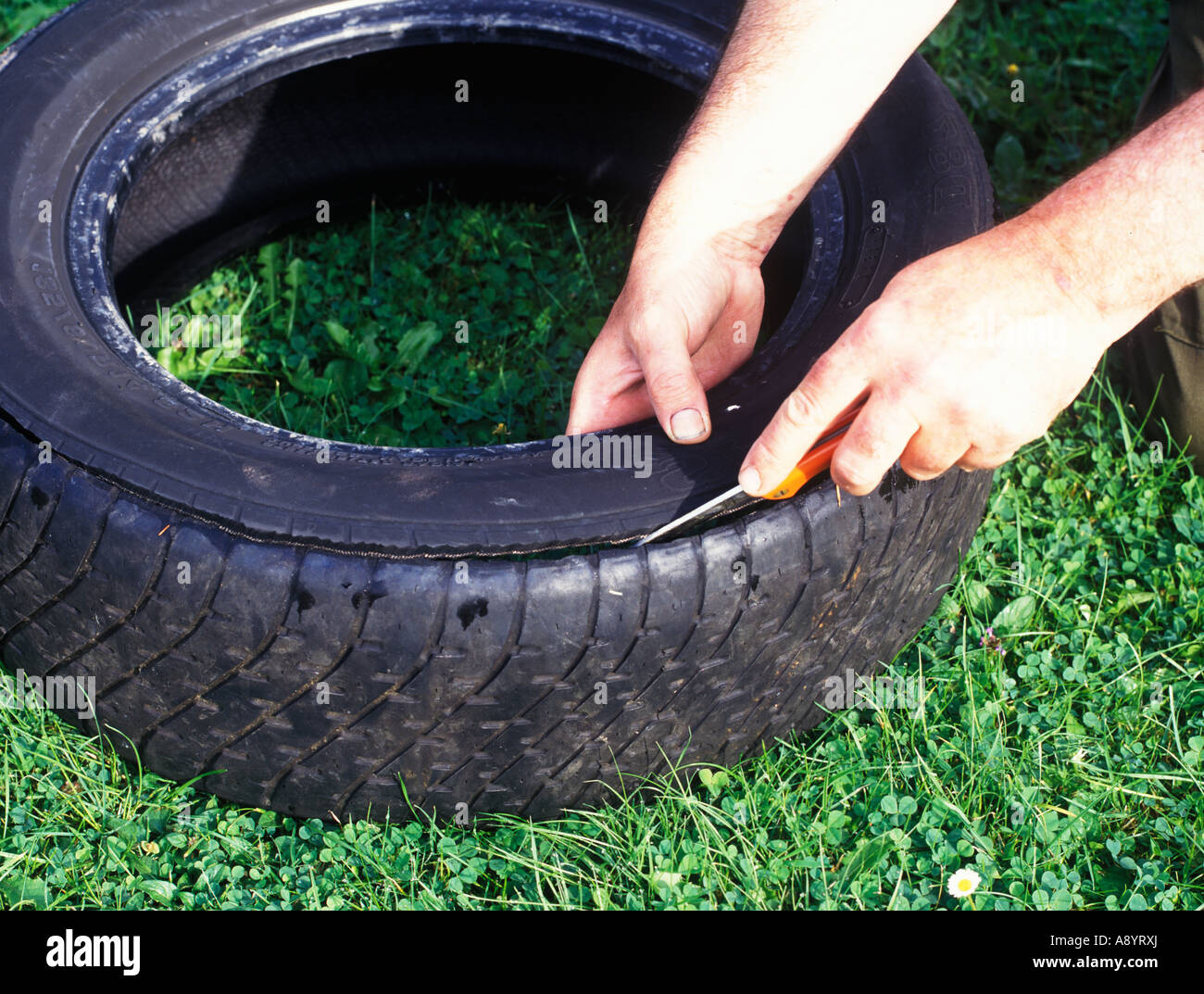 TYRE CONTAINER STEP2 CUT OUT THE RIMS Stock Photo - Alamy