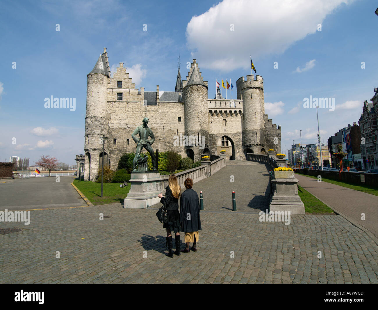 Two female tourists photographing the Lange Wapper statue at het Steen ...