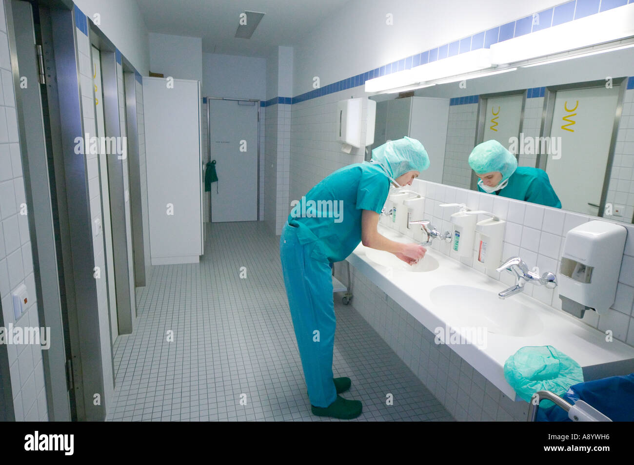 anesthesiologist disinfects his hands before entering operating room ...