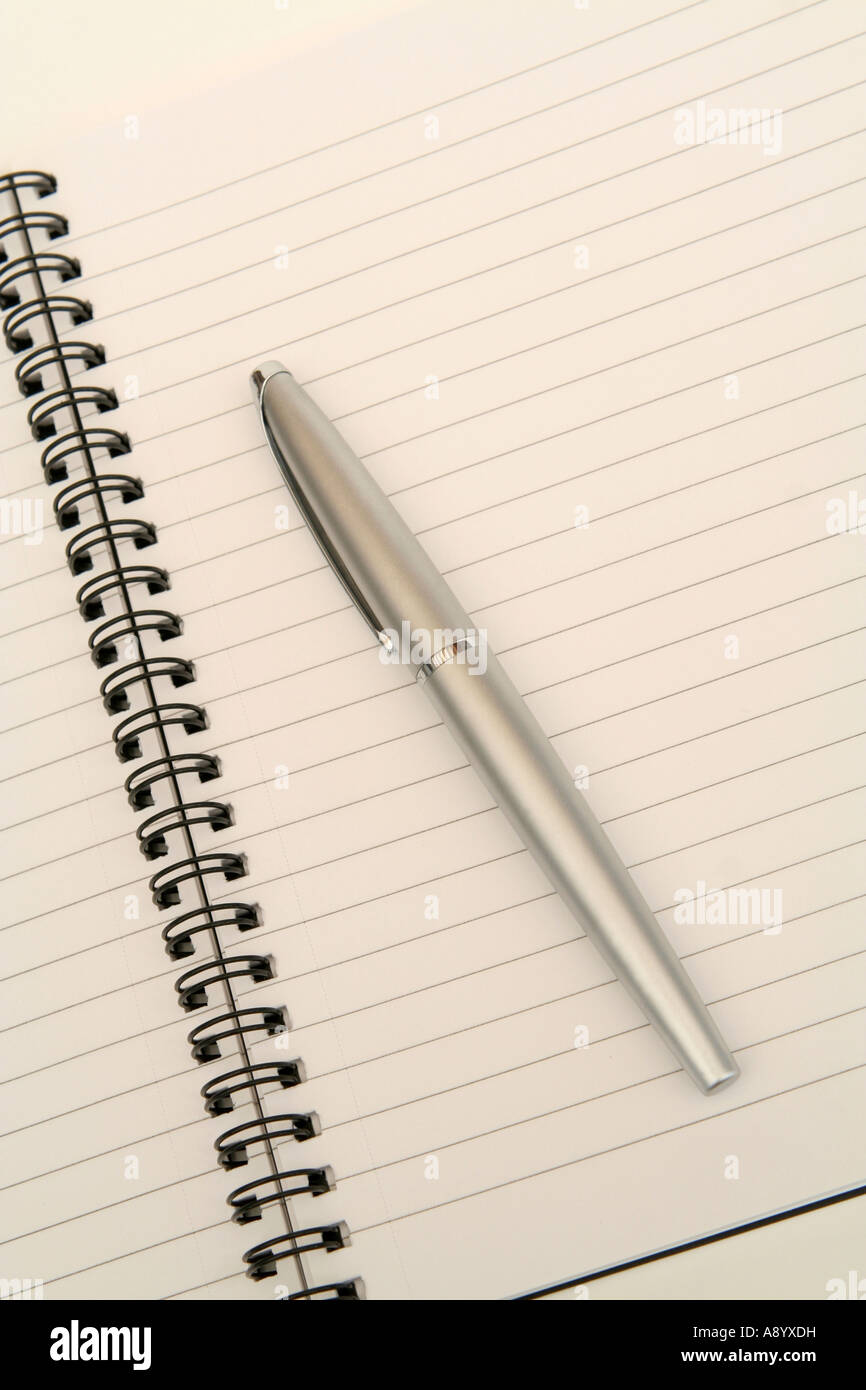 A pen lying on a page of an open notebook Stock Photo - Alamy