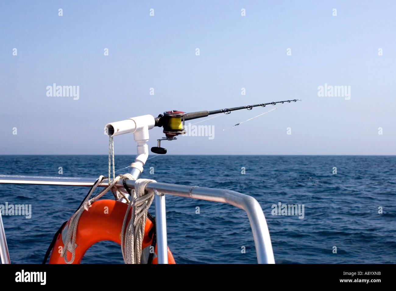 Fishing reel on bow of boat Stock Photo - Alamy