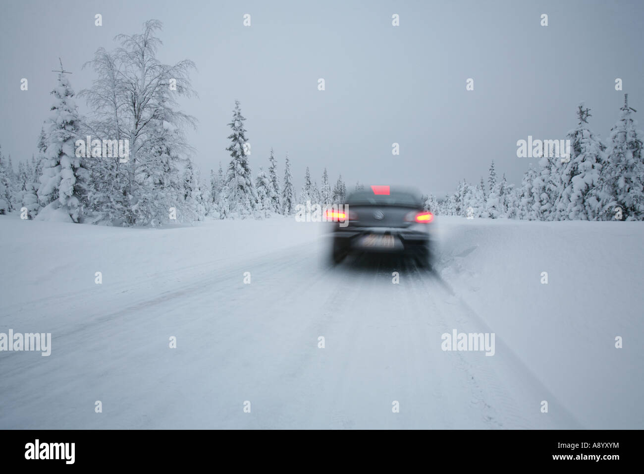 Car braking on snow covered road in Lapland's Arctic landscape Stock ...