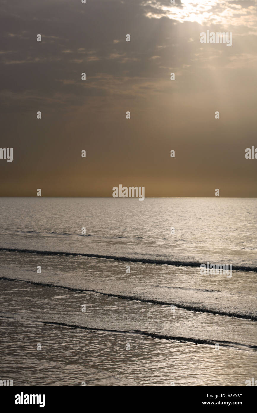 Incoming waves during sunset Stock Photo - Alamy