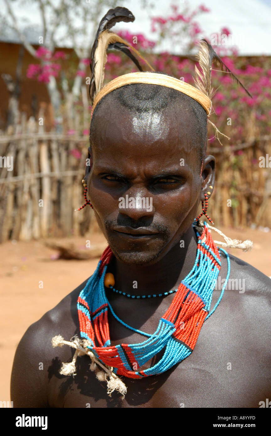 Man of the Hamar people with colourful neckless wearing feathers on his ...