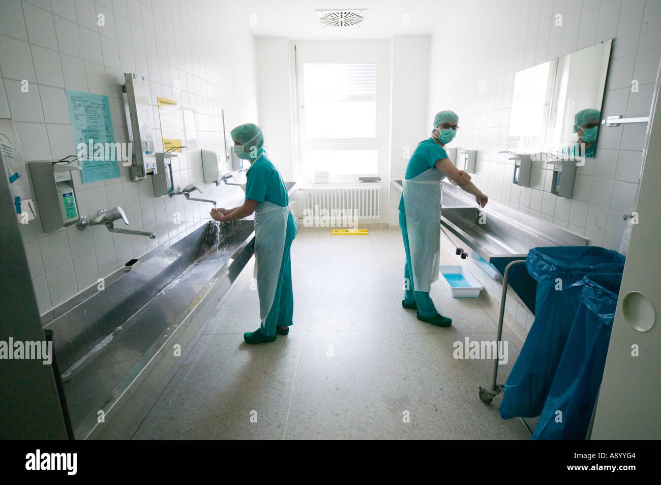Anesthesiologists disinfect hands entering operating hi-res stock ...