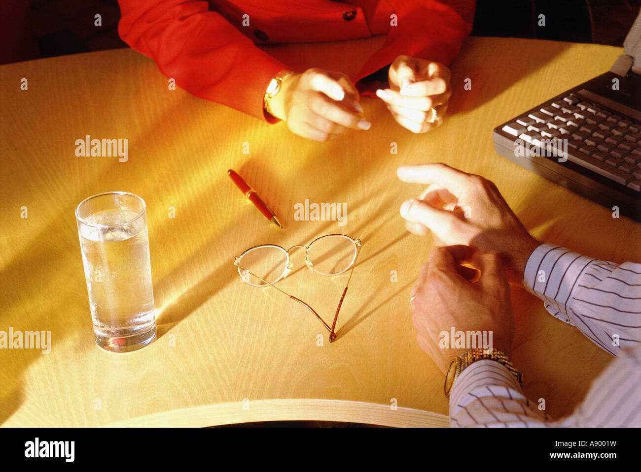 Close up of hands at table at business meeting Stock Photo - Alamy