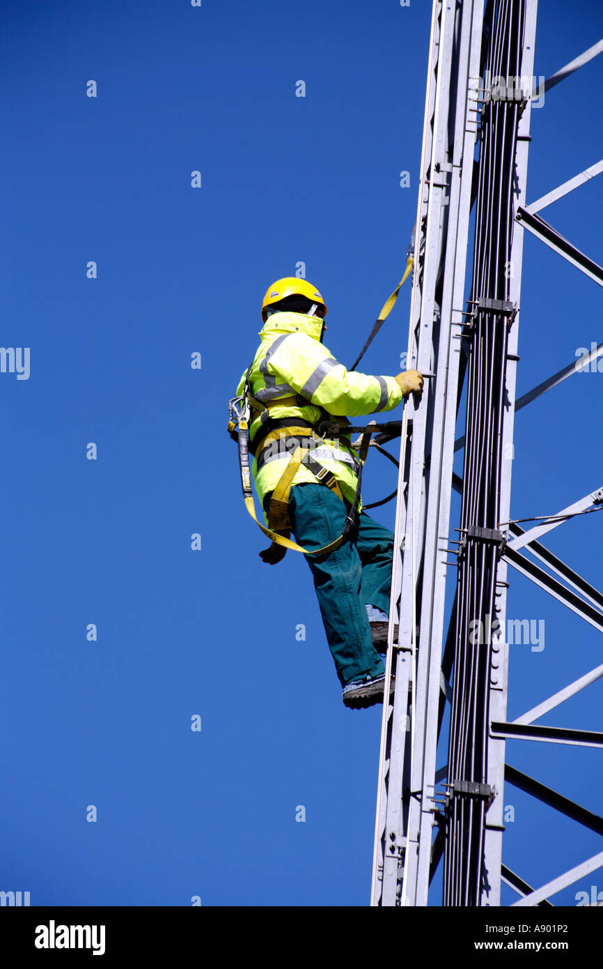 Rigger working on mobile phone antennas on steel lattice tower Stock ...