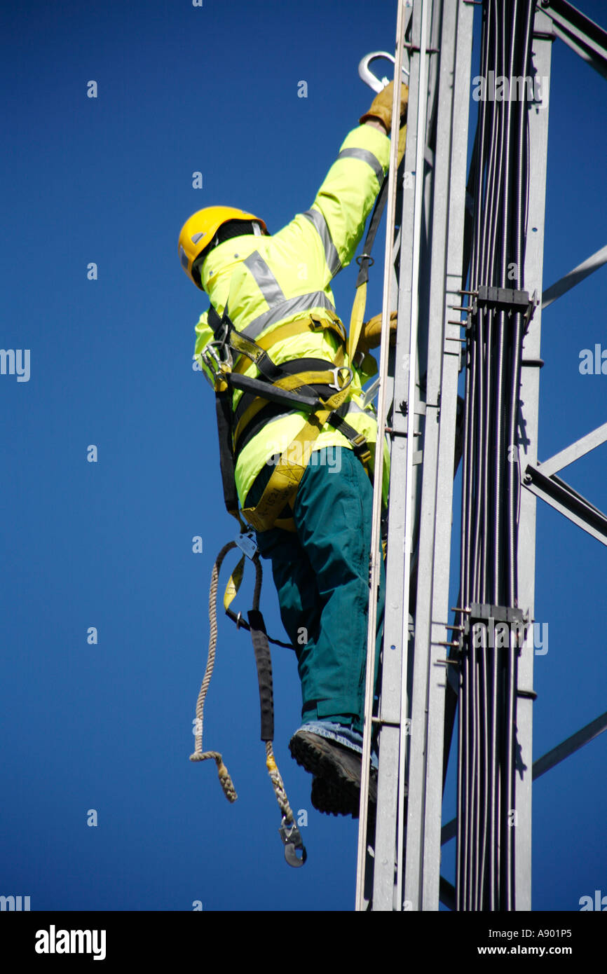 Rigger working on mobile phone antennas on steel lattice tower Stock ...