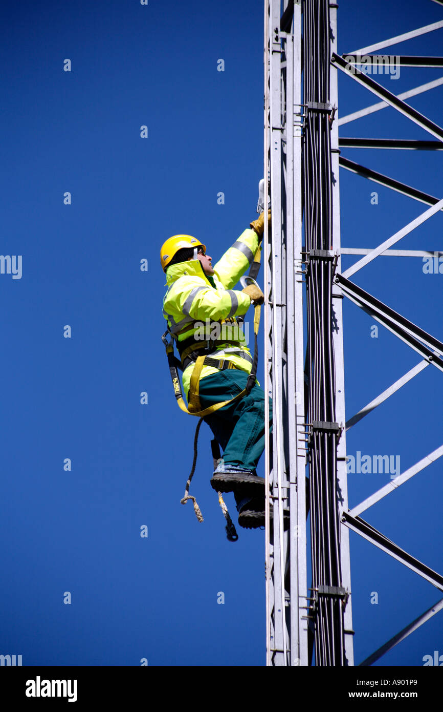 Rigger working on mobile phone antennas on steel lattice tower Stock ...