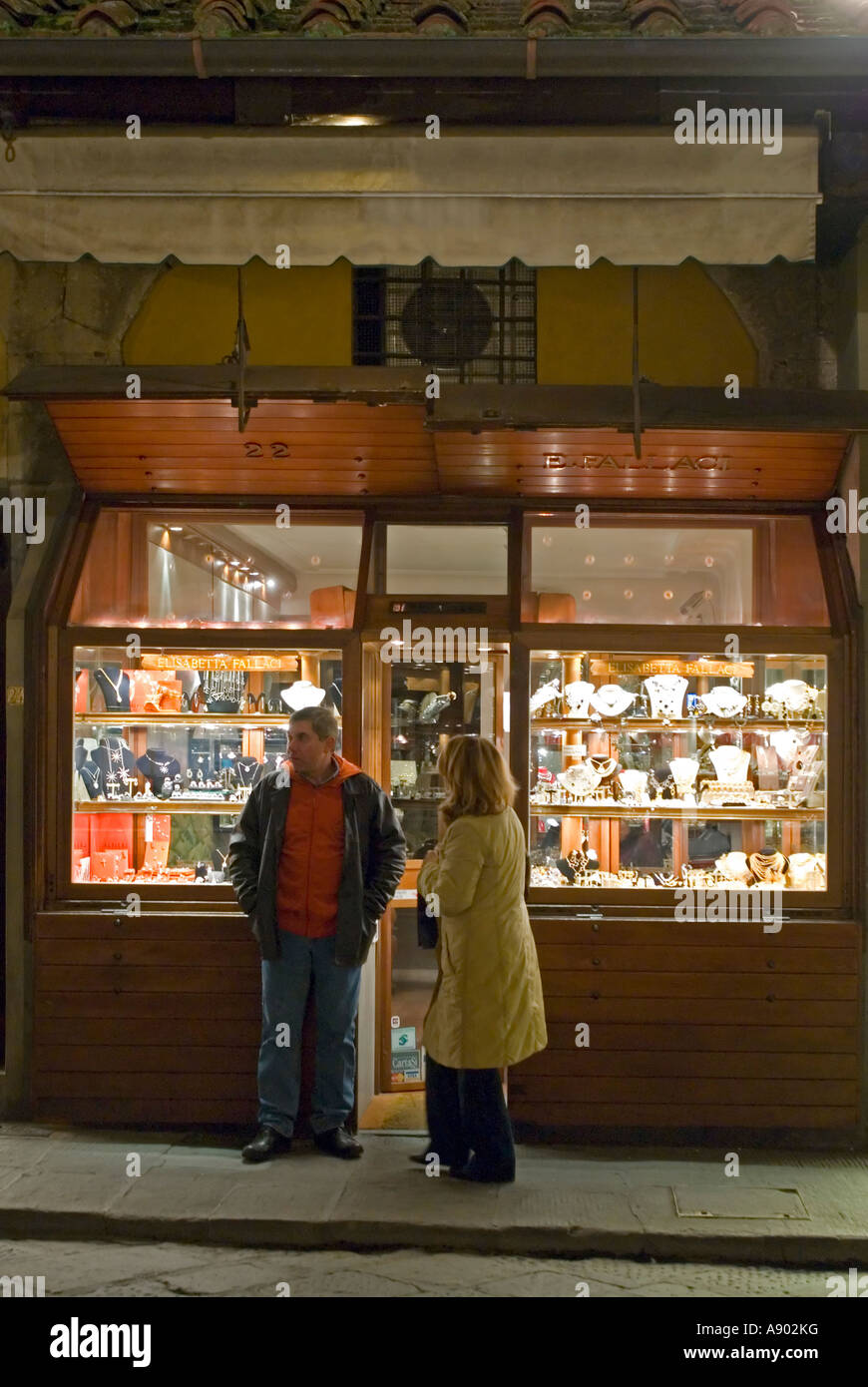 Vertical night time image of a traditional gold shop on the Ponte ...