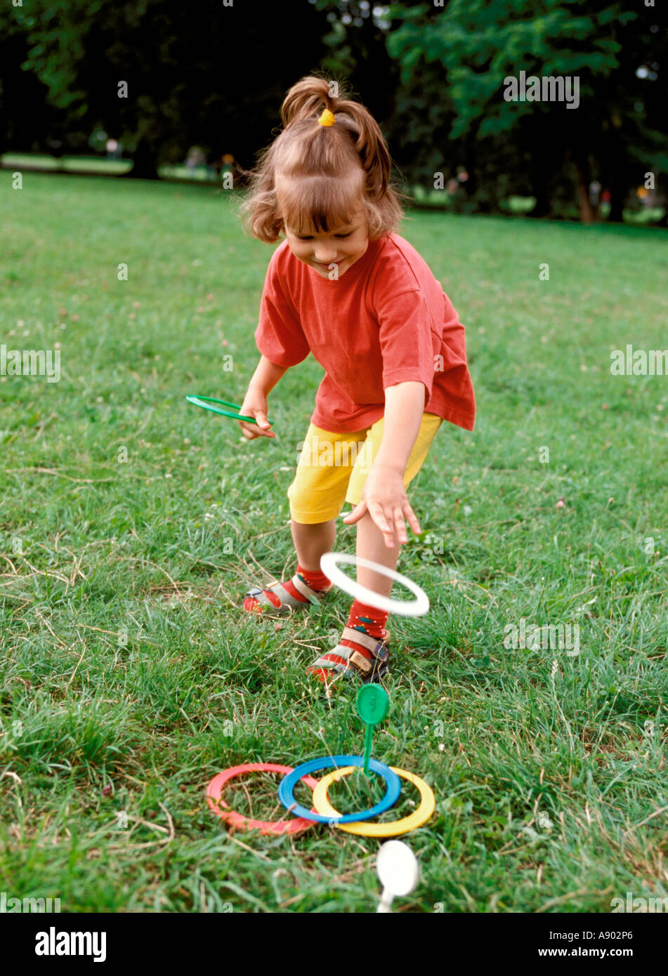 girl playing with circles throwing MR8373 Stock Photo - Alamy
