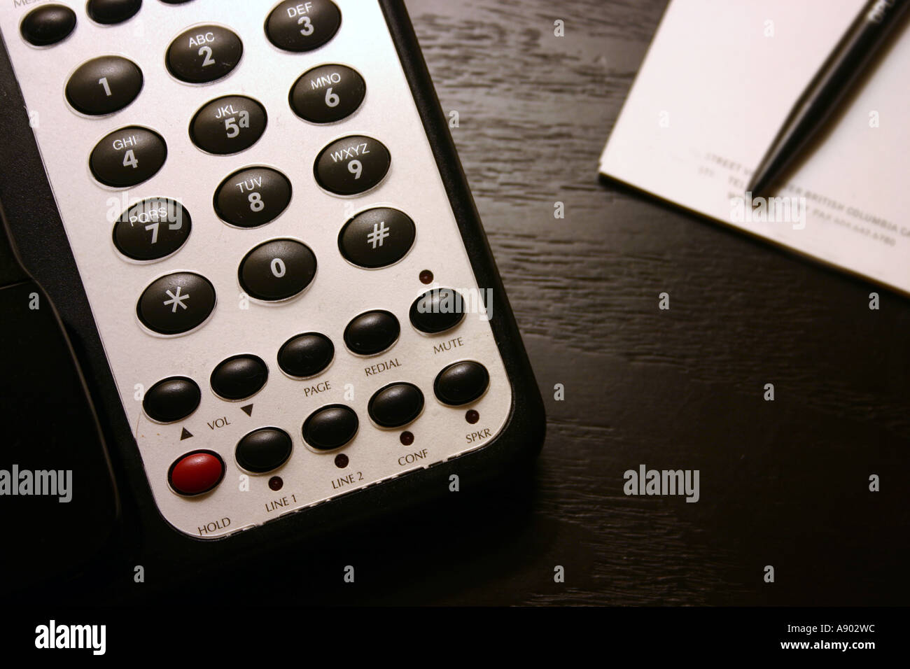 Telephone and notepad on desk Stock Photo - Alamy